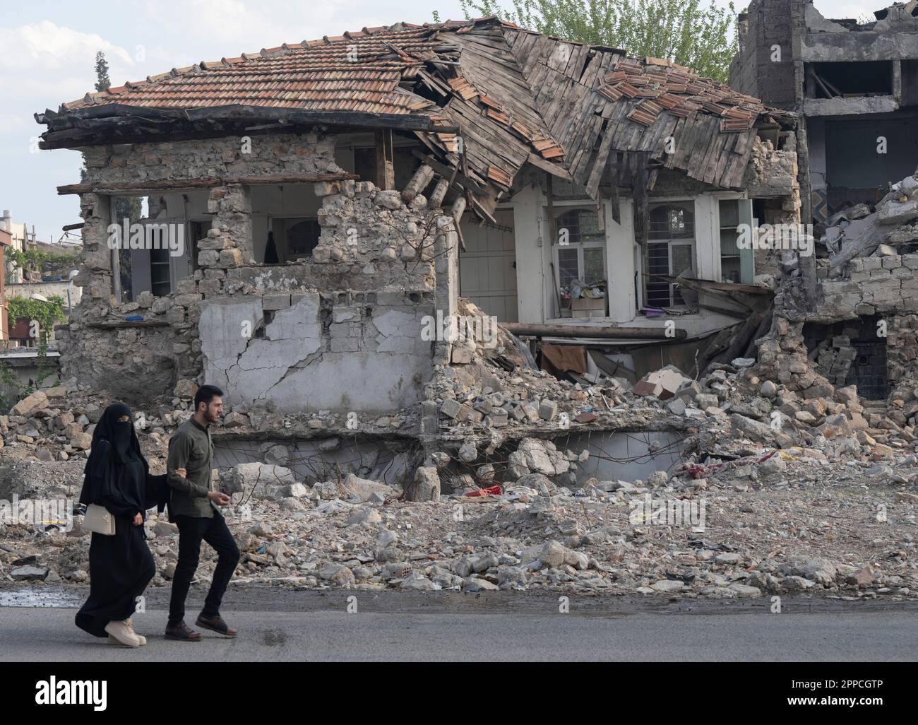 Kahramanmaras, Turkey. 23rd Apr, 2023. A man and a woman walk past ...