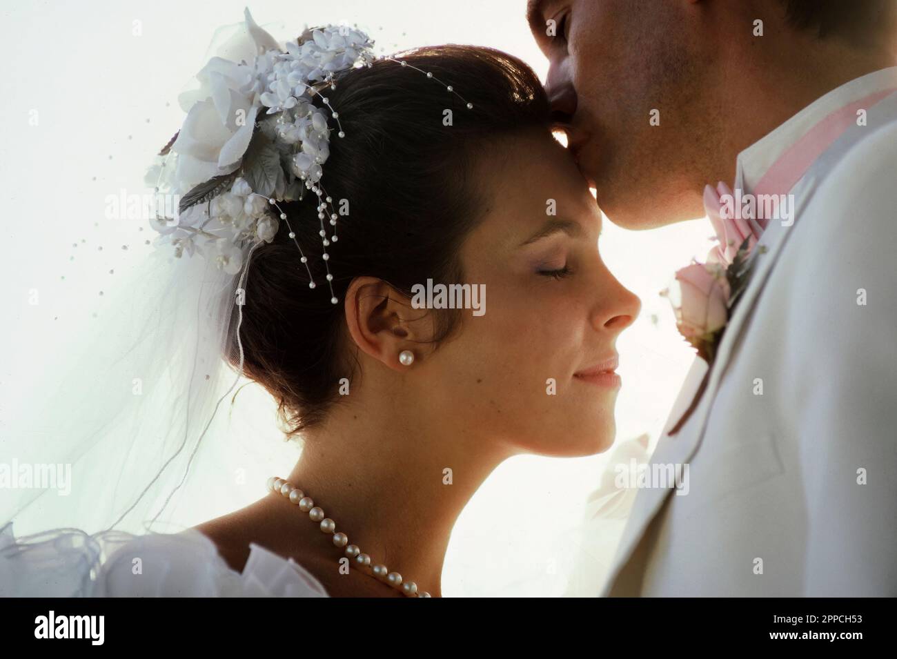 Just married, new Caucasian husband kisses his beautiful young wife on ...