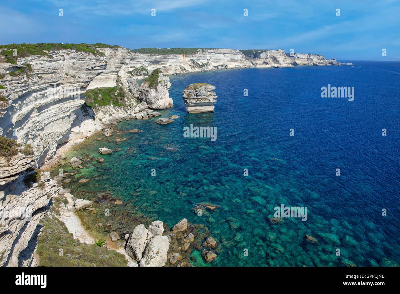 The famous rugged chalk cliffs and turquoise blue sea coast at ...