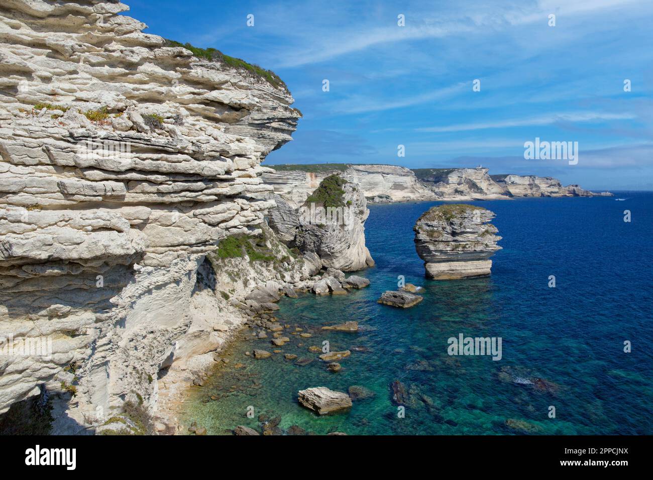 The famous rugged chalk cliffs and turquoise blue sea coast at ...