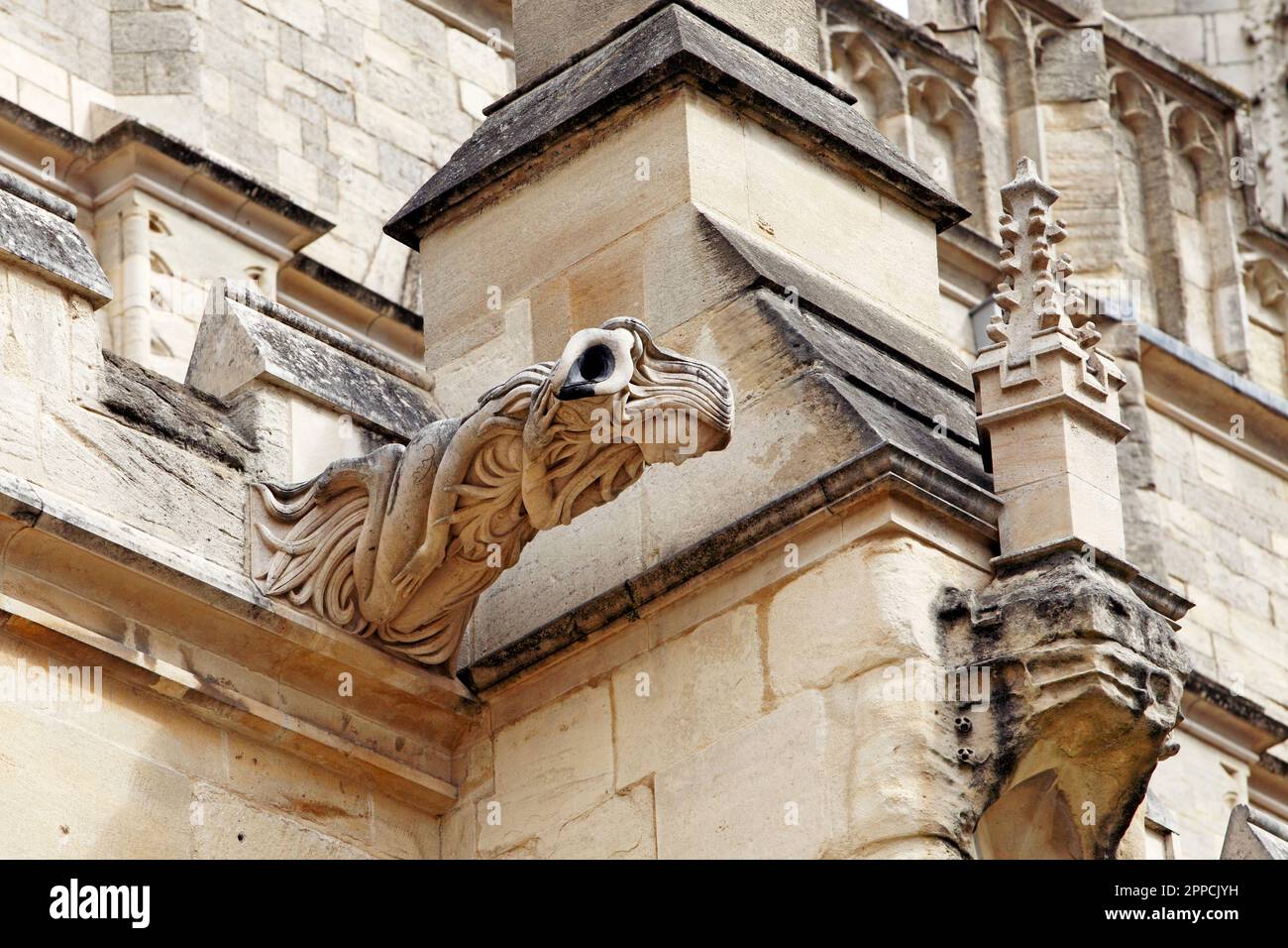 Gargoyle or grotesque on a water drain outlet on Gloucester Cathedral ...
