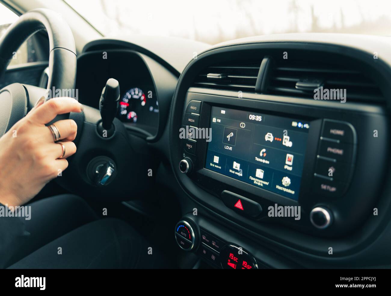 Women's hands control the car, dashboard, radio Stock Photo - Alamy