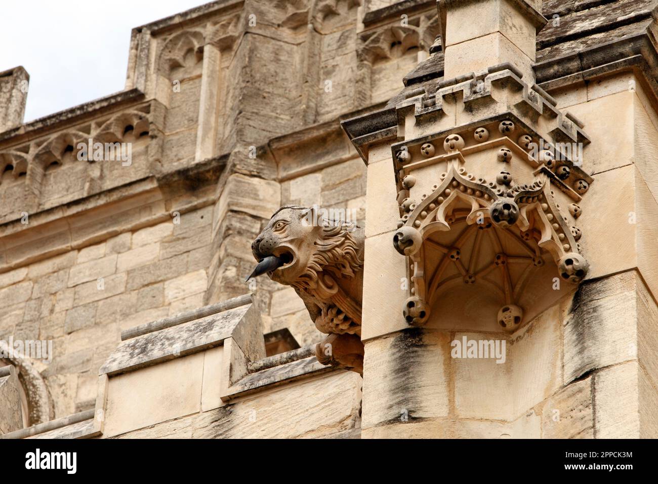 Gargoyle or grotesque on a water drain outlet on Gloucester Cathedral ...