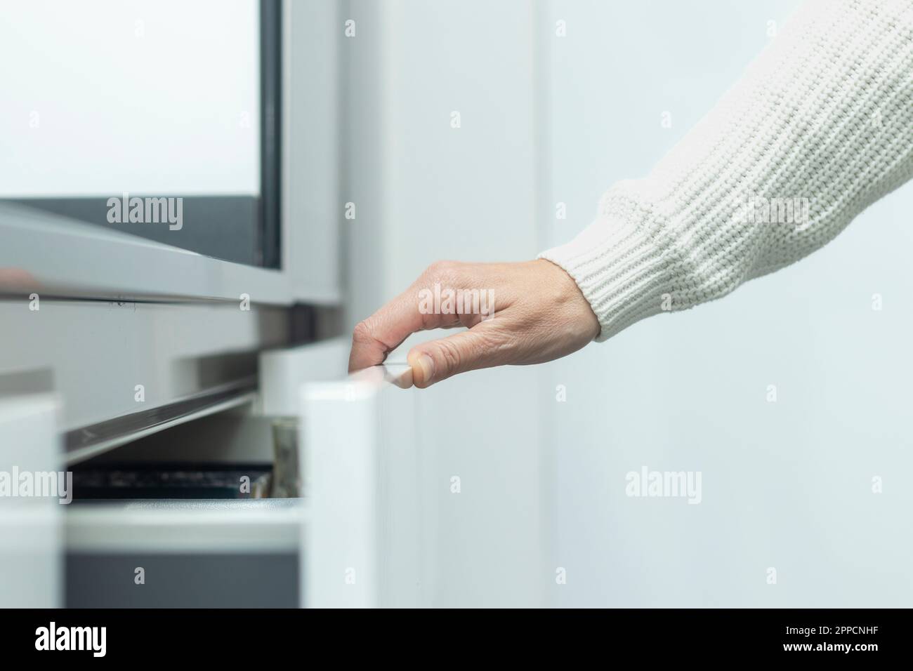 Organized Cutlery Drawer: a Woman's Hand Pulling Open Kitchen Cabinet ...