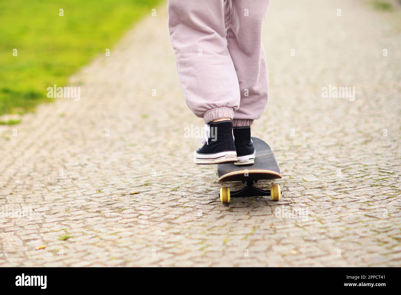 Skateboarder skateboarding on city street Stock Photo - Alamy