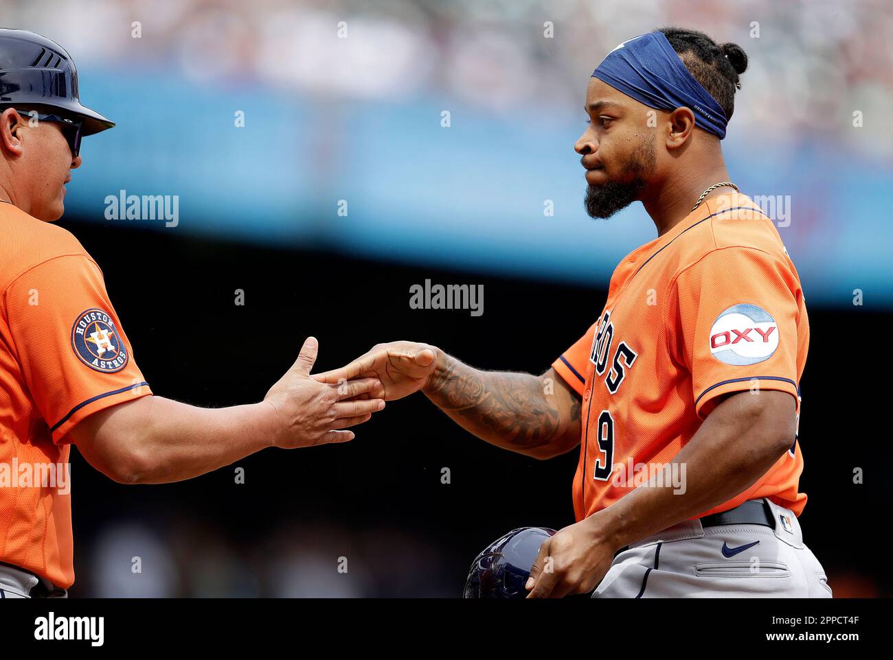 Houston Astros' Corey Julks, right, celebrates with first base coach ...