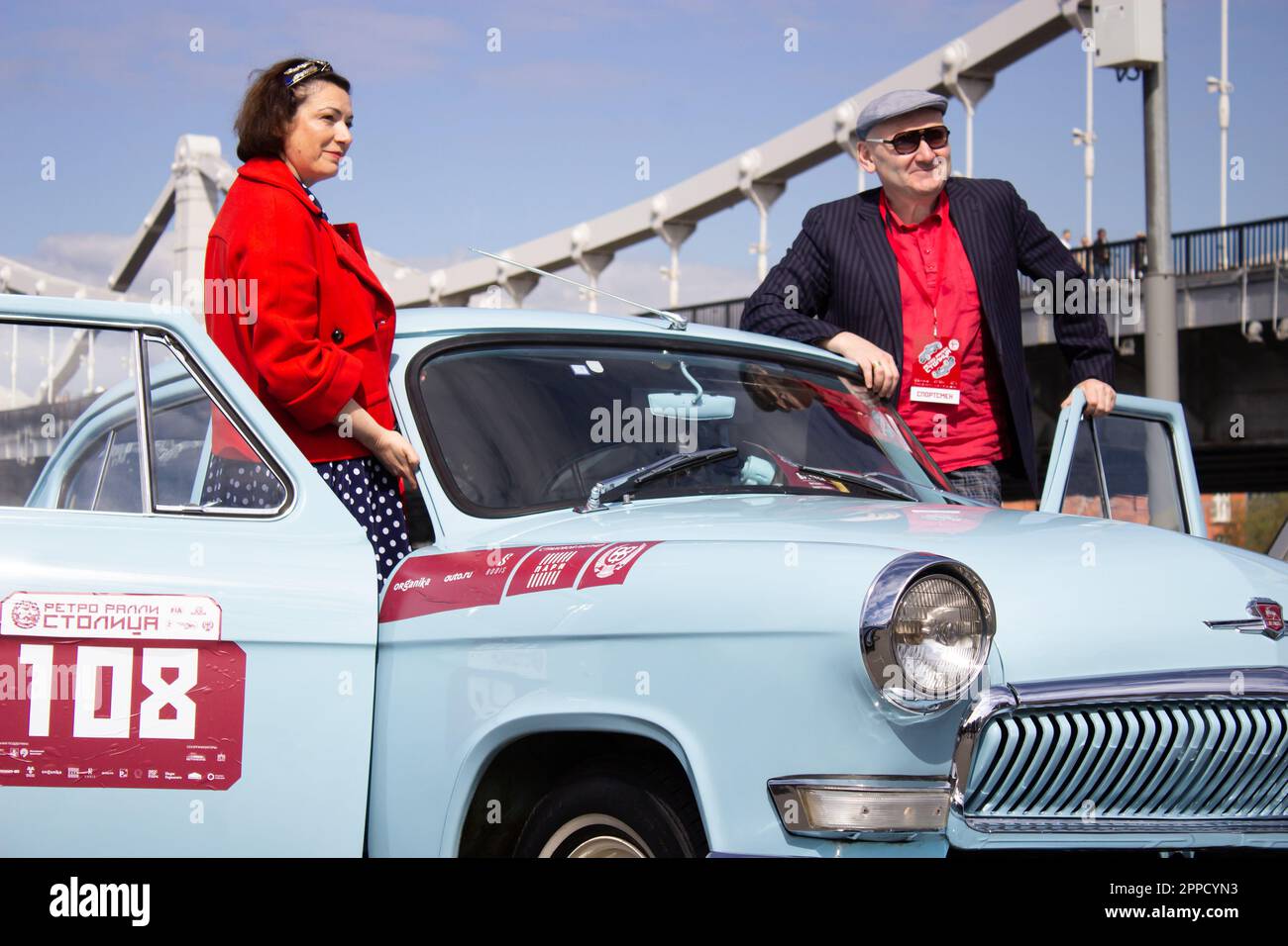 Owners pose next to their Soviet-made GAZ-23 "Volga" parked near the ...