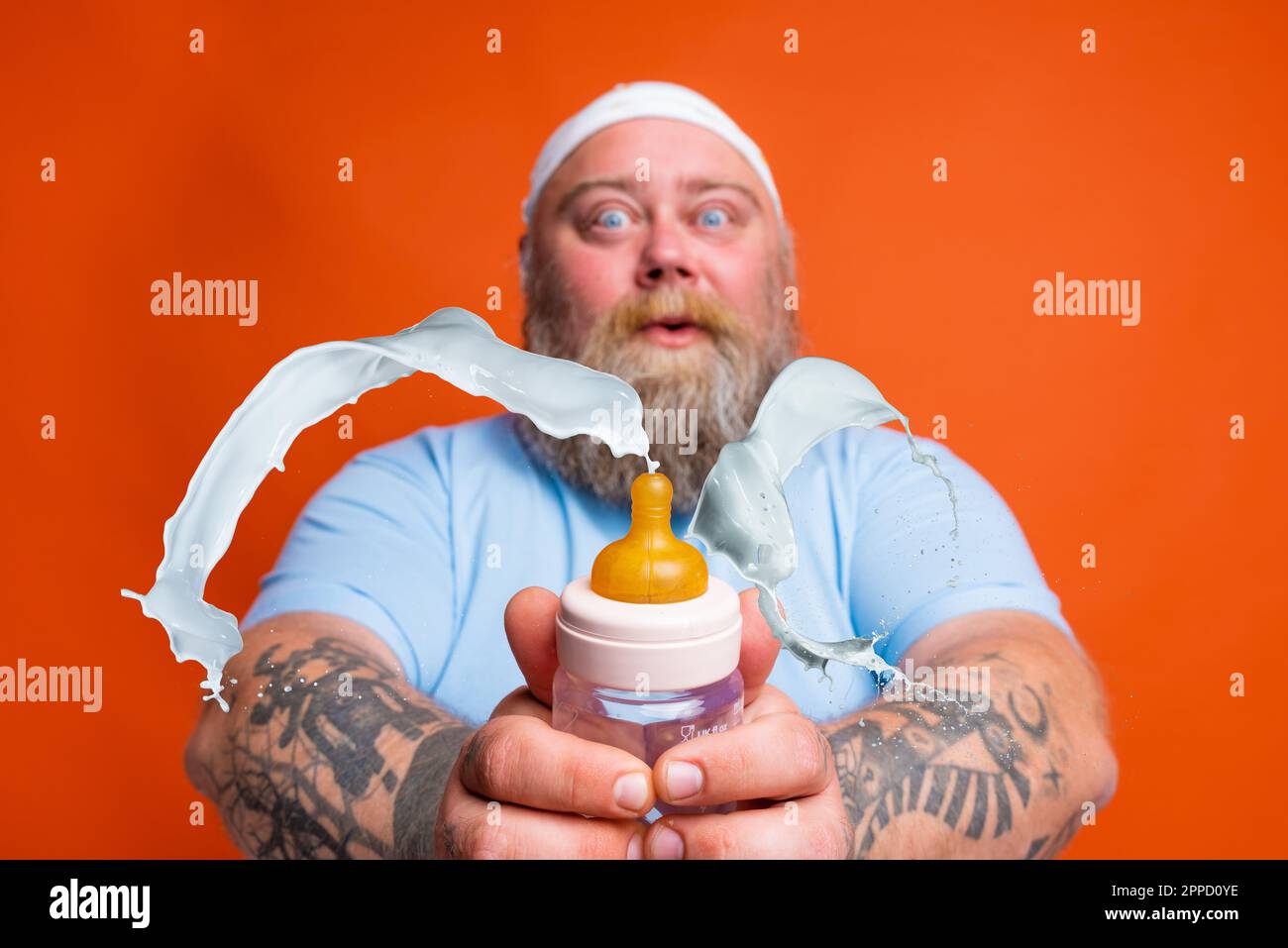 Fat man acts like a child a baby bottle in hand Stock Photo - Alamy