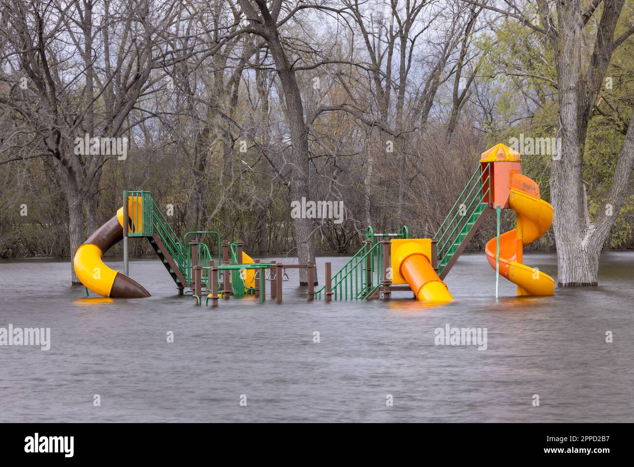 Playground equipment submerged in floodwaters during spring Stock Photo ...