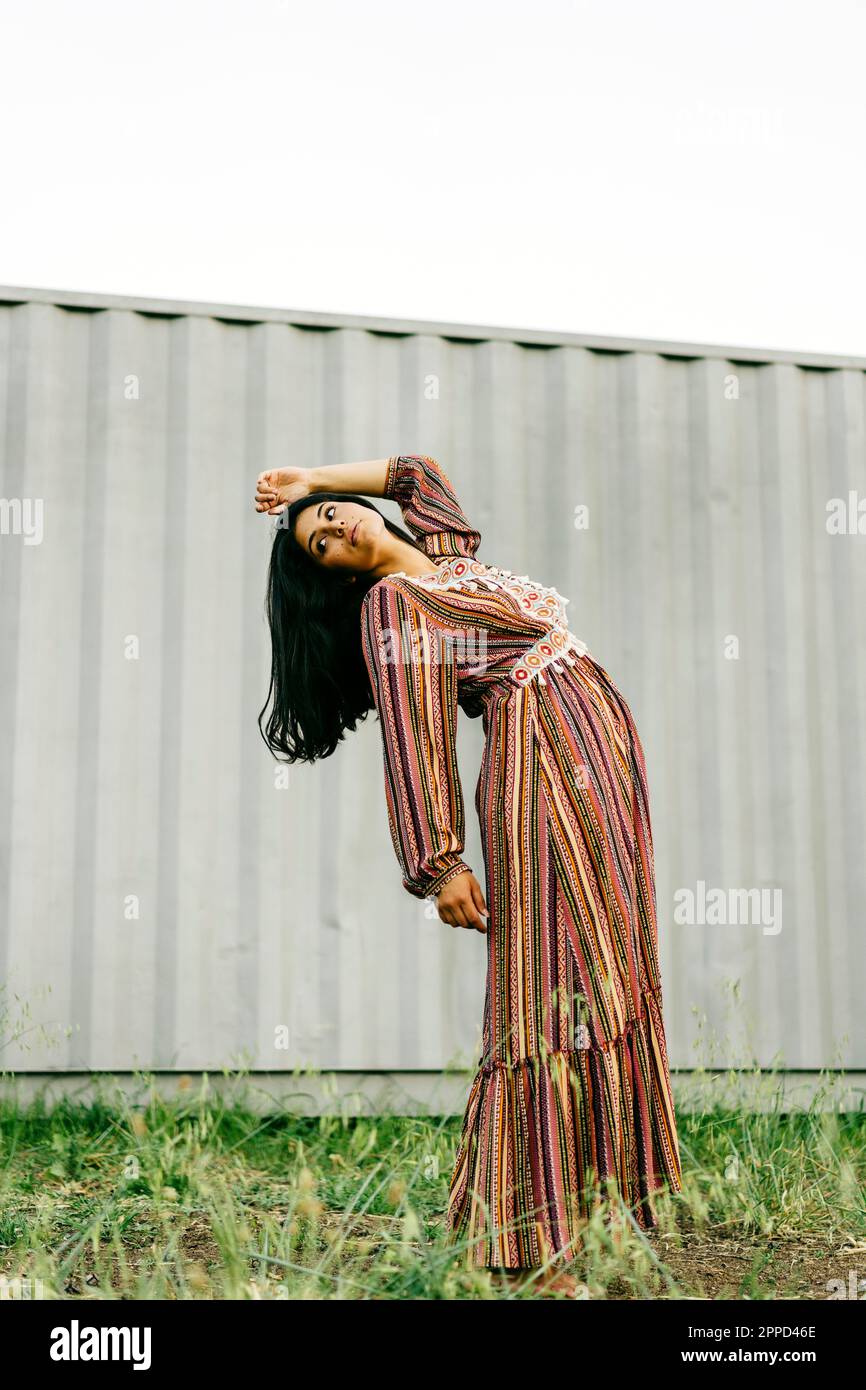 Young woman bending backwards in front of container home Stock Photo ...