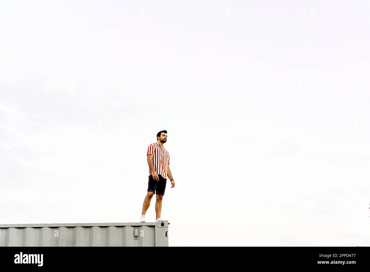 Man standing on top of container home under sky Stock Photo - Alamy