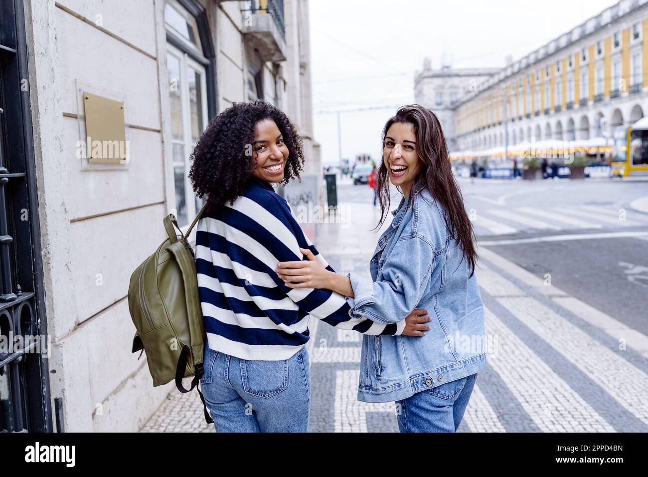 Happy young friends walking hi-res stock photography and images - Alamy