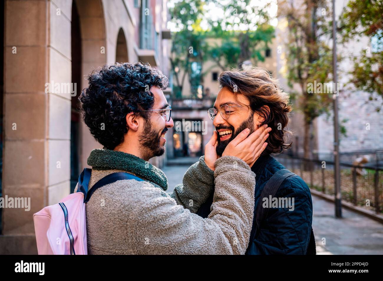 Smiling gay man caressing face of boyfriend Stock Photo - Alamy