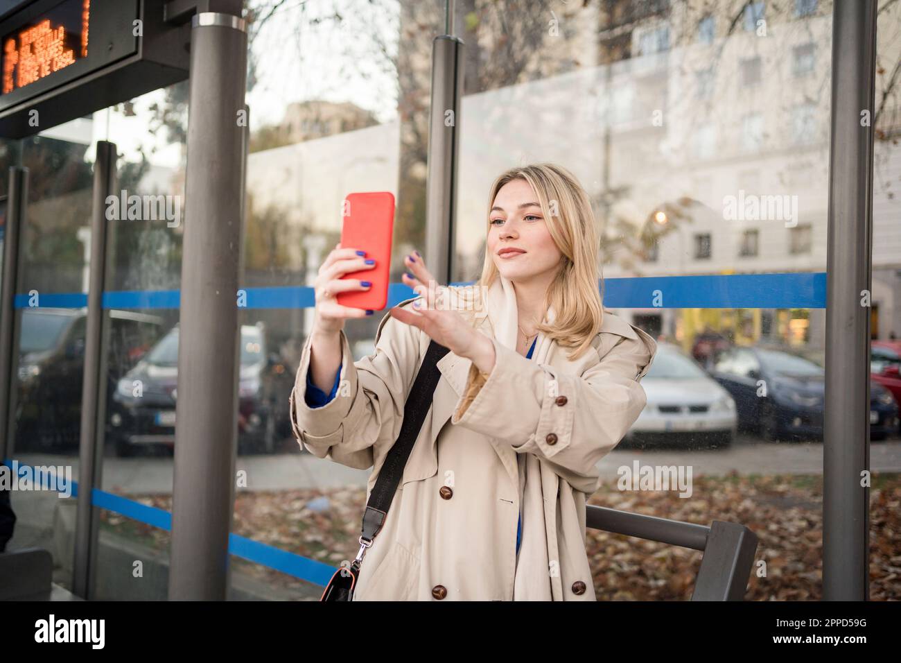 Woman smartphone waiting bus stop hi-res stock photography and images ...