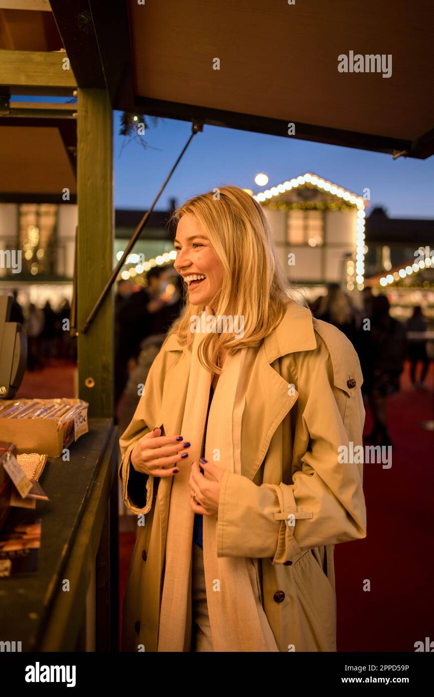 Happy woman standing outside concession stand Stock Photo - Alamy