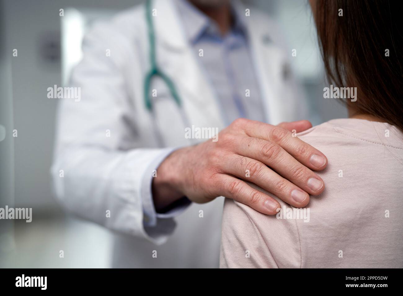 Doctor consoling patient at clinic Stock Photo - Alamy
