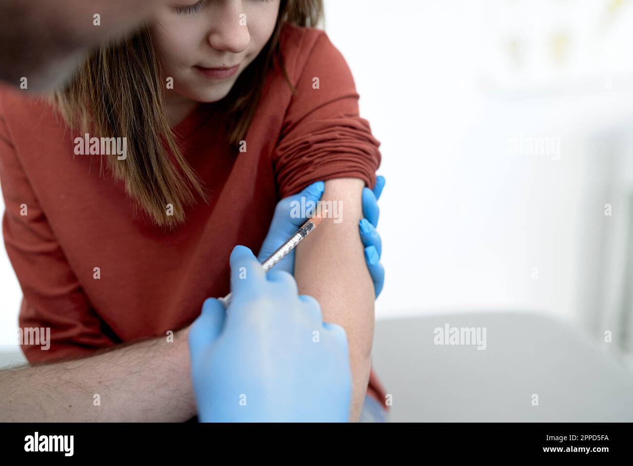 Hands of doctor giving vaccination to patient in clinic Stock Photo - Alamy
