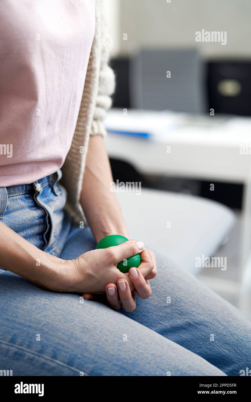 Woman holding stress ball at clinic Stock Photo - Alamy