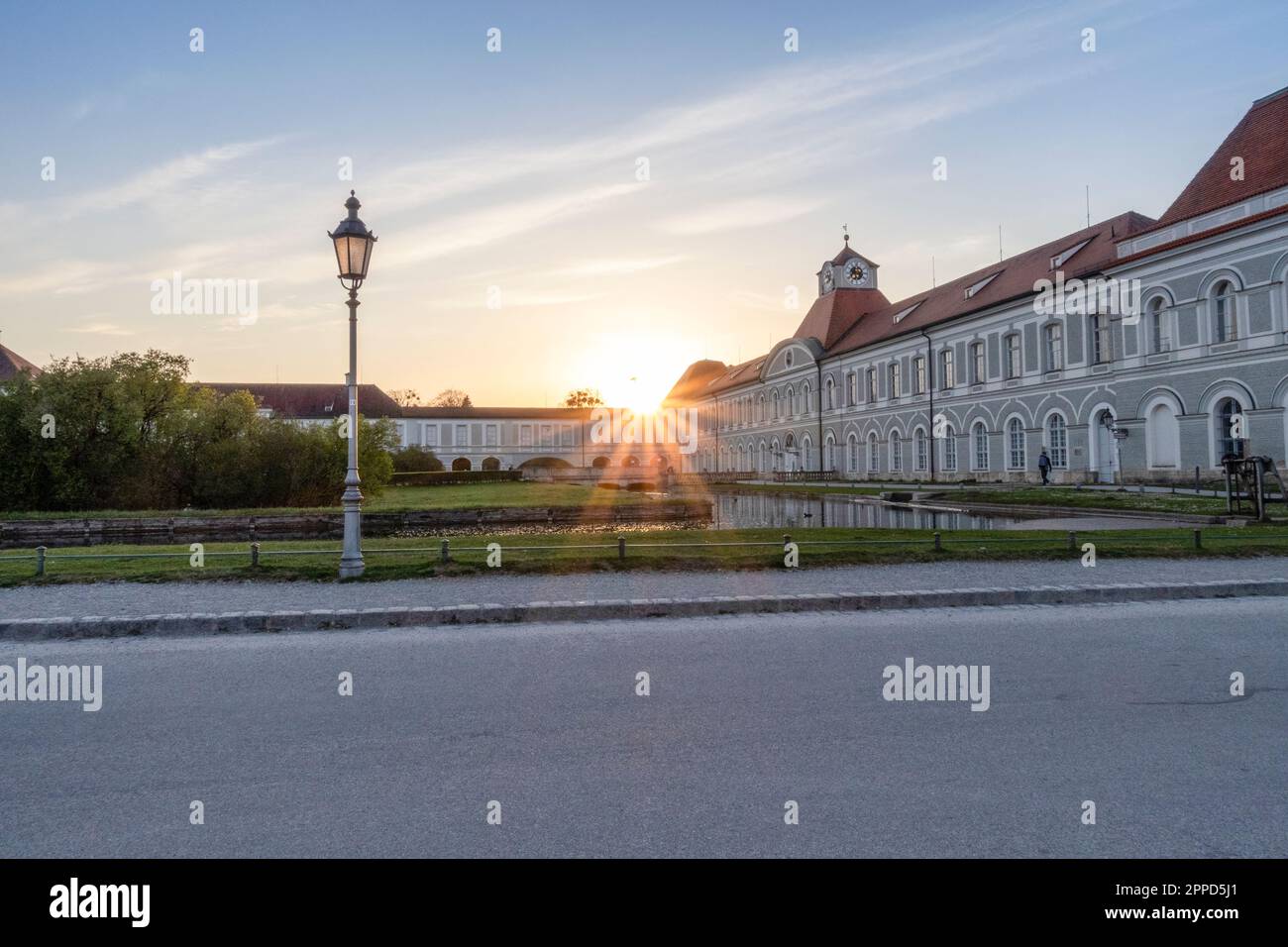 Germany, Bavaria, Munich, Sun setting over Nymphenburg Palace with ...