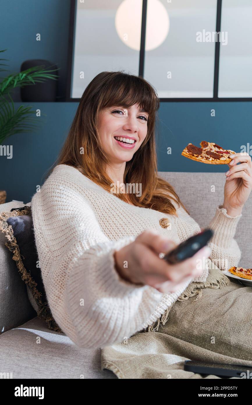 Happy woman spending leisure time watching TV at home Stock Photo - Alamy