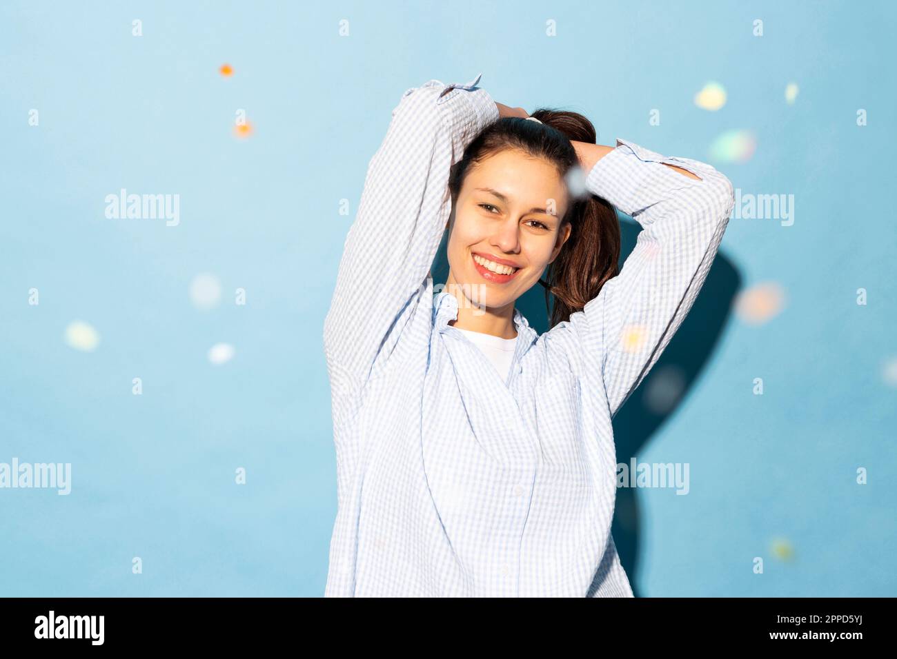 Woman happy blue background hi-res stock photography and images - Alamy
