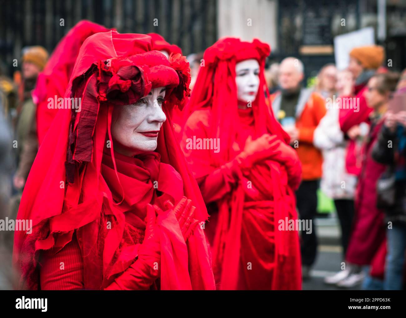Red Rebel Brigade, performance activists march past the Houses of ...
