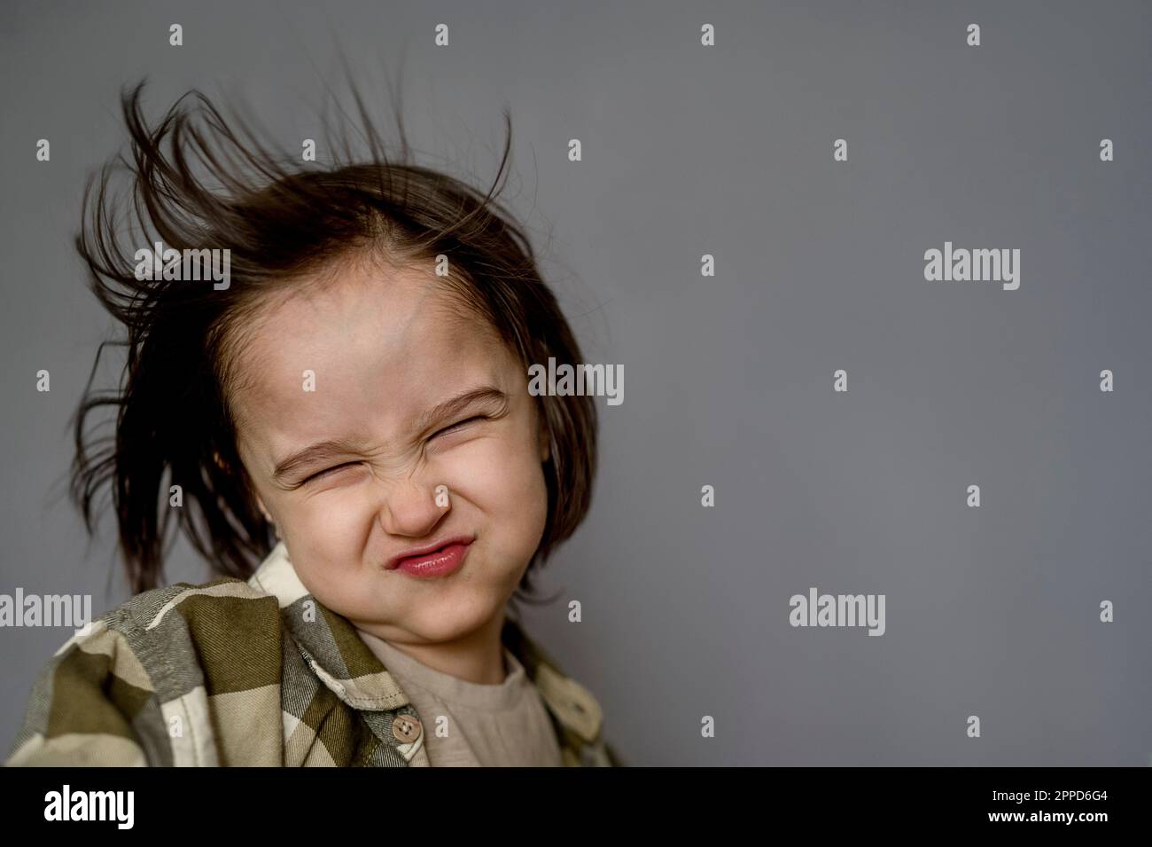 Boy making face standing against gray background Stock Photo - Alamy Boy making face standing against gray background Stock Photo - Alamy