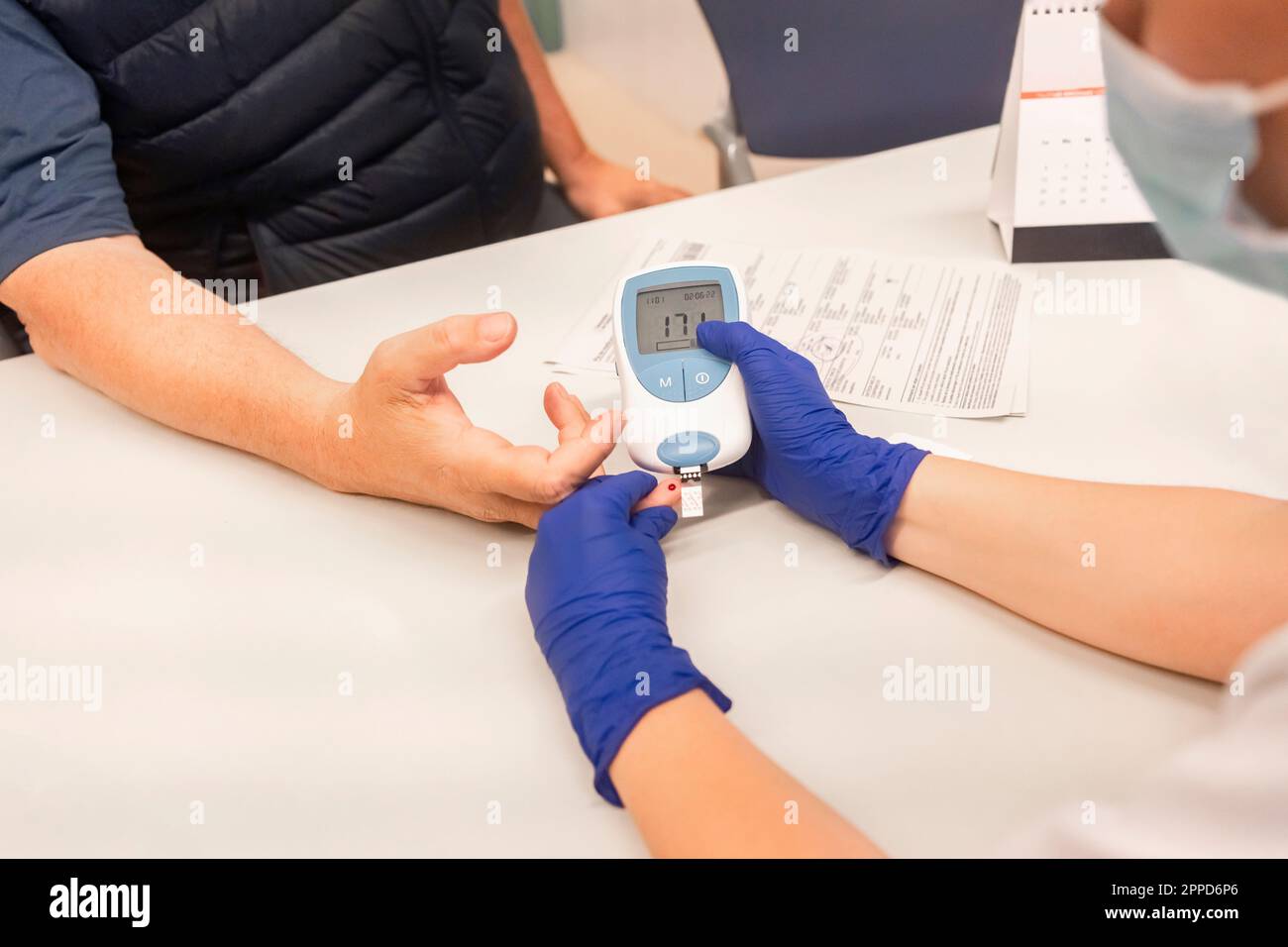 Doctor checking blood sugar level of patient at clinic Stock Photo - Alamy