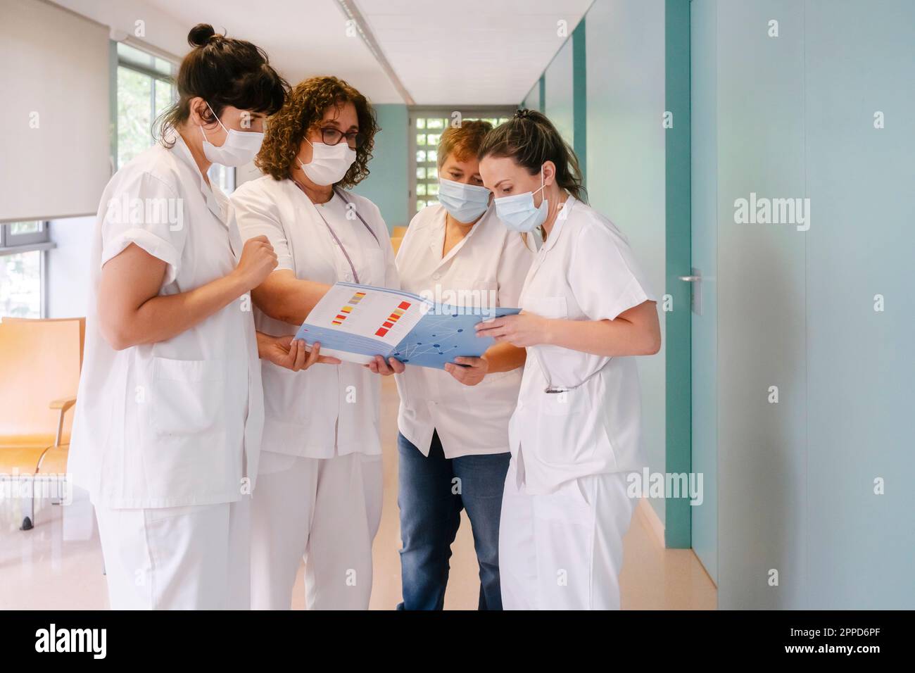 Doctor explaining medical report to colleagues standing at hospital ...