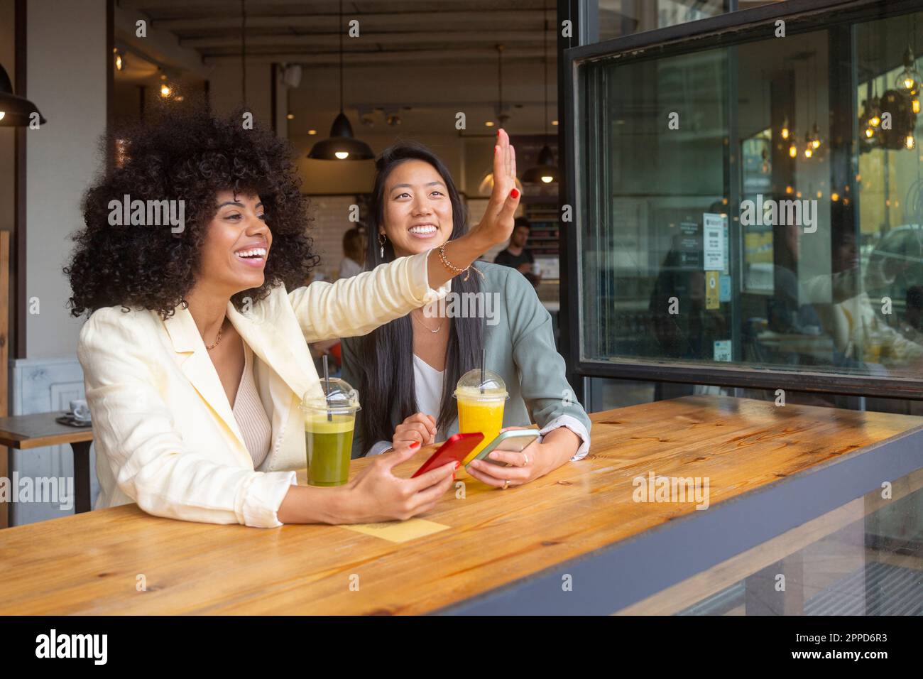 Greeting friends cafe hi-res stock photography and images - Alamy