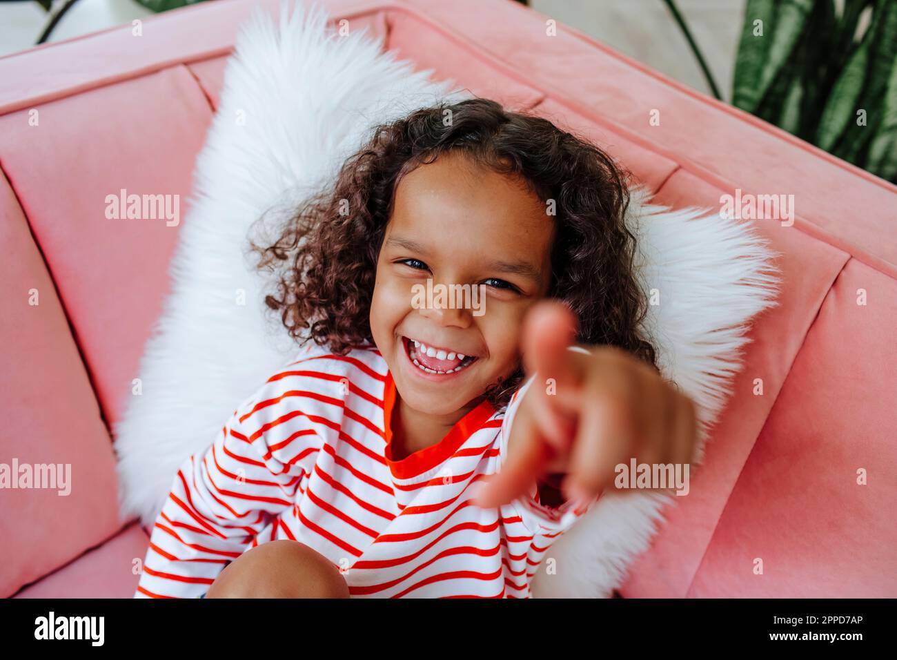 Happy child girl sitting sofa hi-res stock photography and images - Alamy