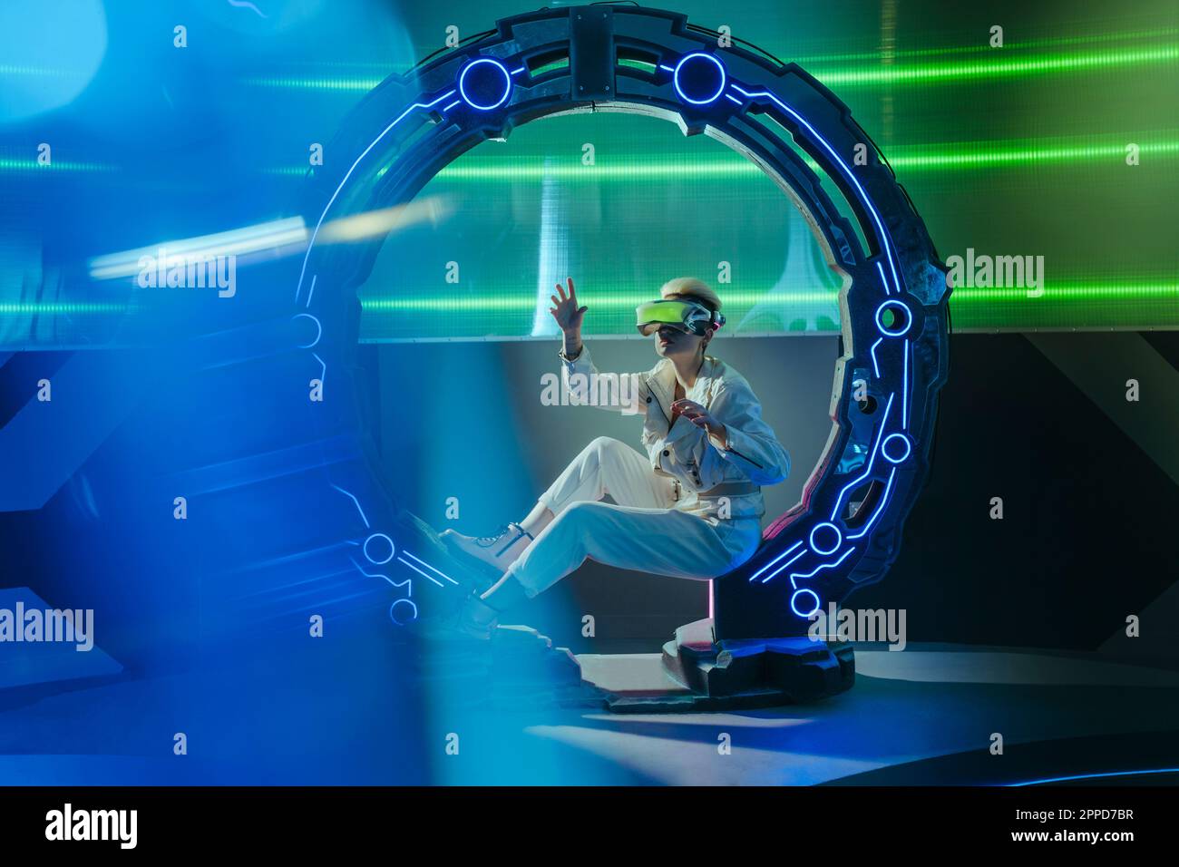 Woman wearing virtual reality simulators sitting in futuristic circle ...