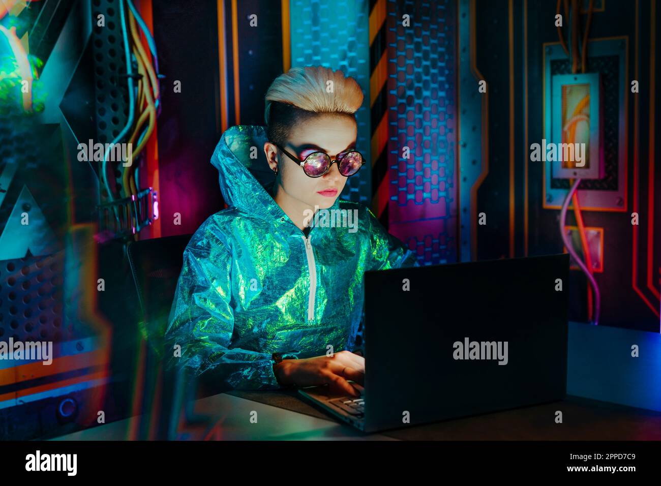 Gamer wearing eyeglasses playing video games on laptop at desk Stock ...