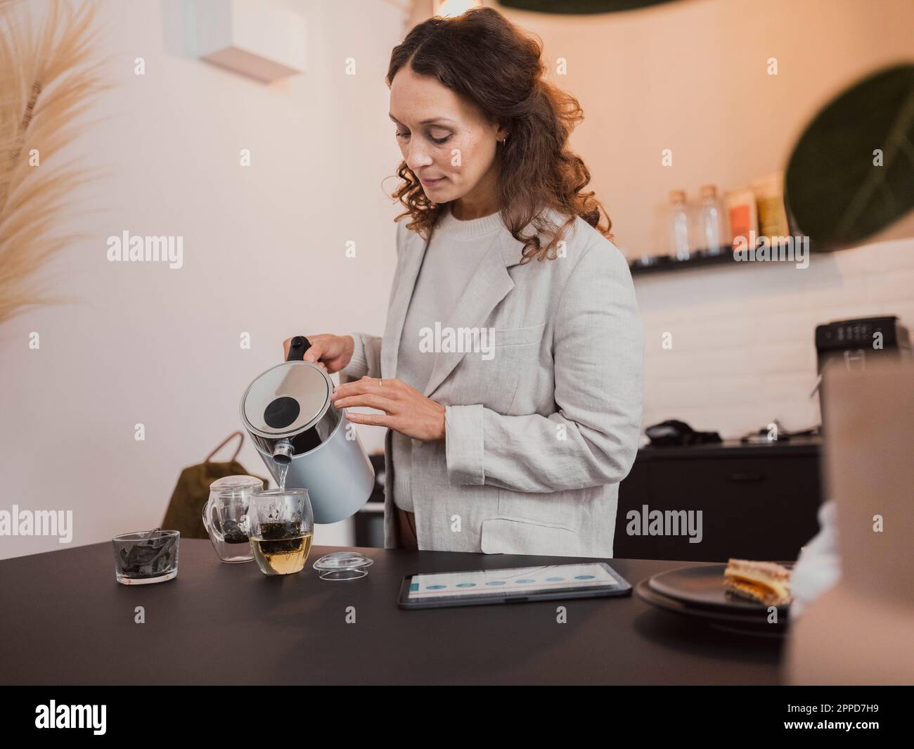 Woman making tea in kitchen at home Stock Photo - Alamy
