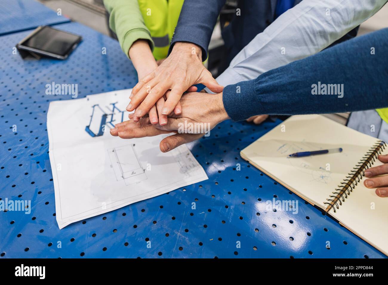 Engineers stacking hands togetherness in unity Stock Photo - Alamy