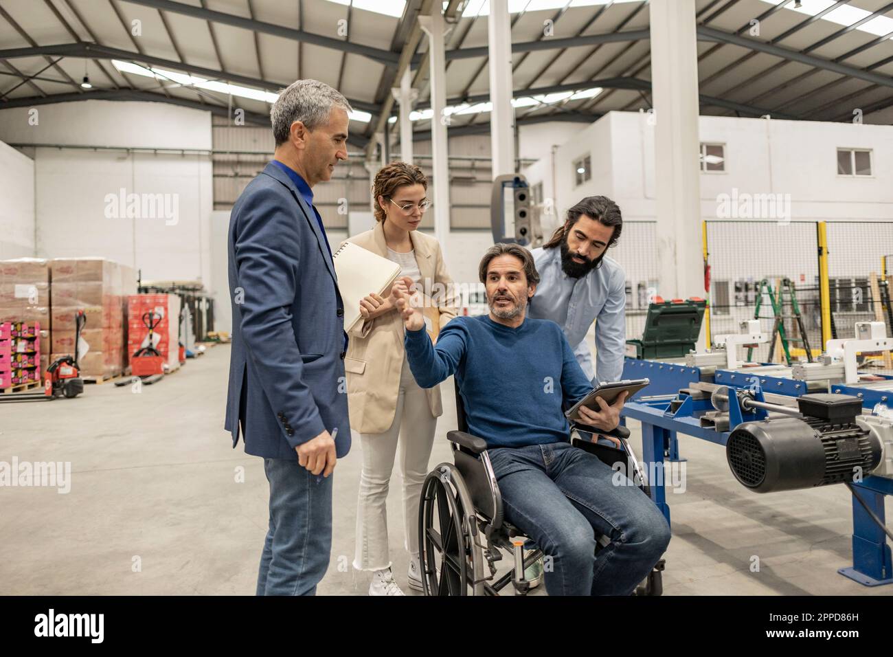 Disabled engineer having discussion with colleagues in industry Stock ...