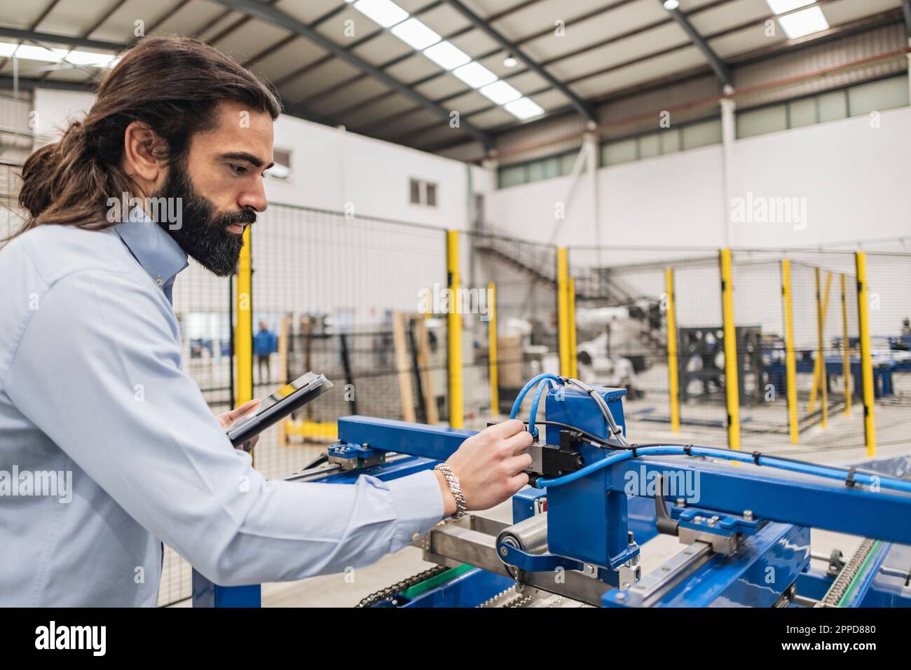 Engineer operating machinery in industry Stock Photo - Alamy