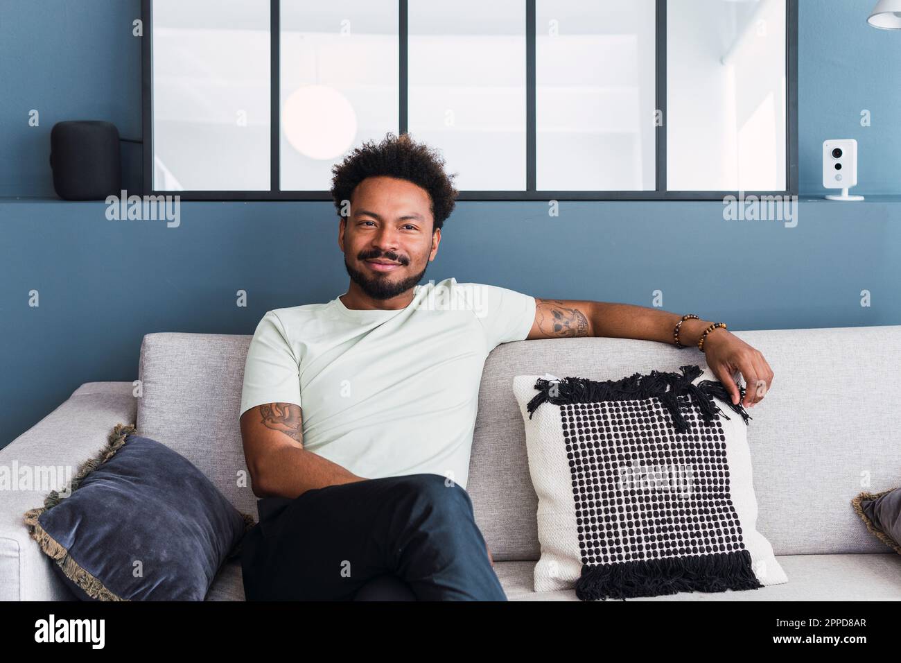 Afro american man on sofa hi-res stock photography and images - Alamy