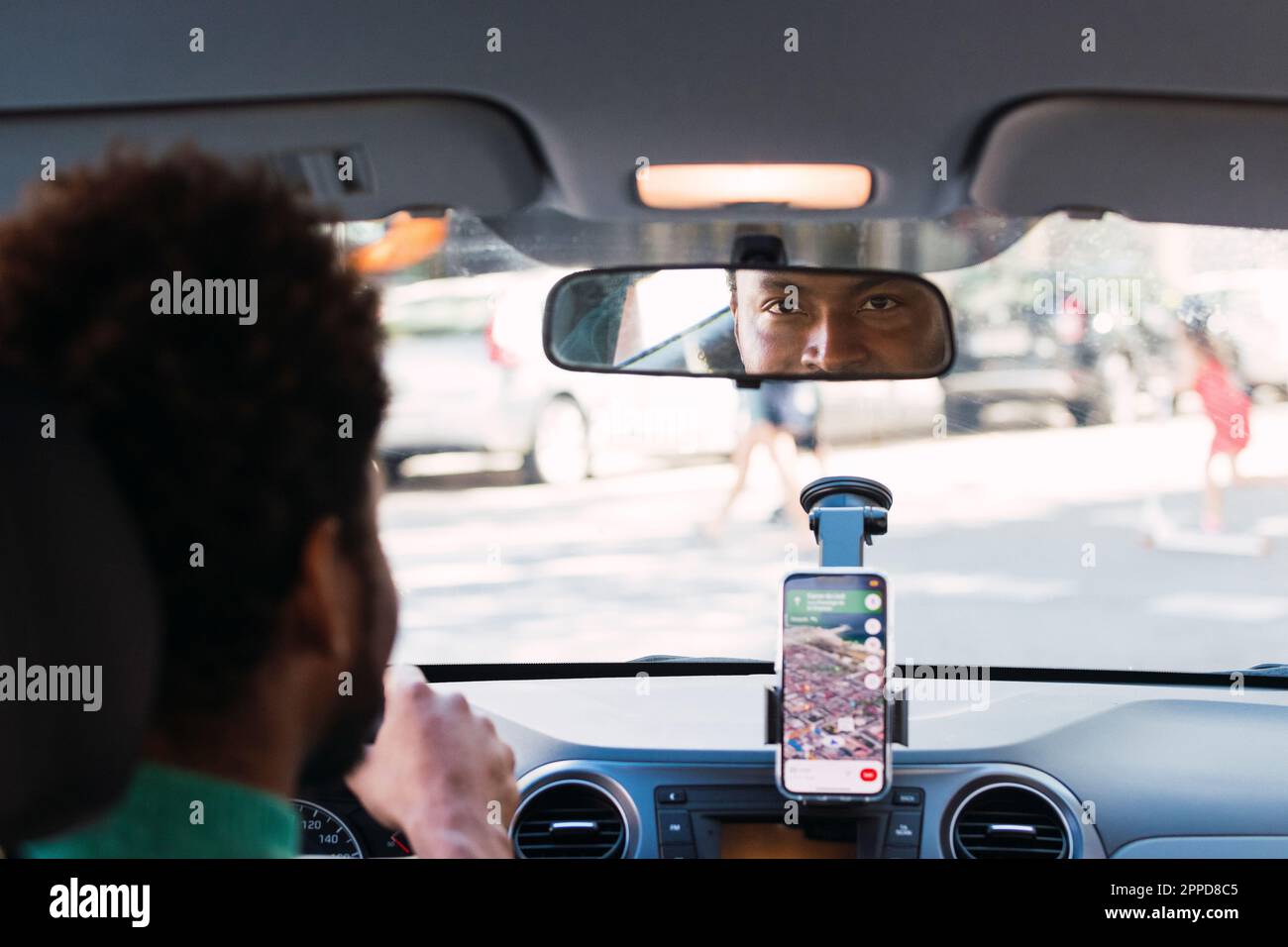 Man looking in rear-view mirror of car Stock Photo - Alamy