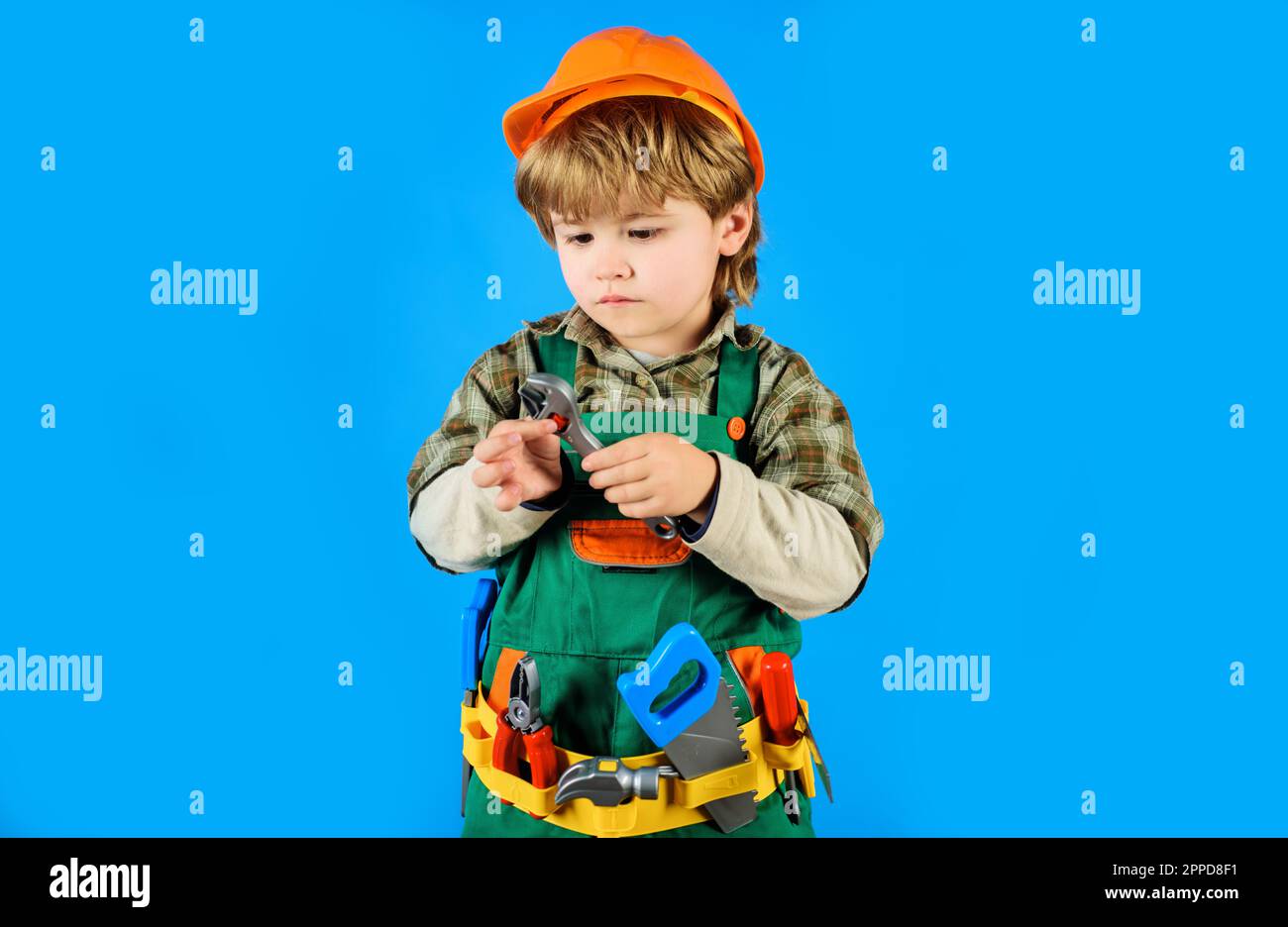 Little repairman with wrench. Child in builder uniform and construction ...