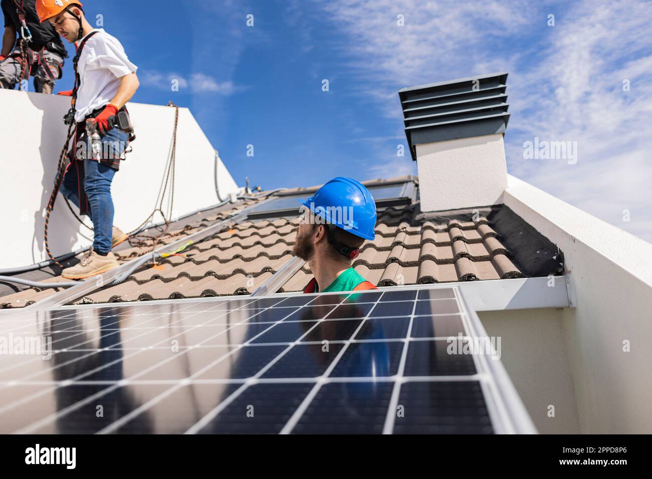 Engineers installing solar panel on rooftop Stock Photo - Alamy