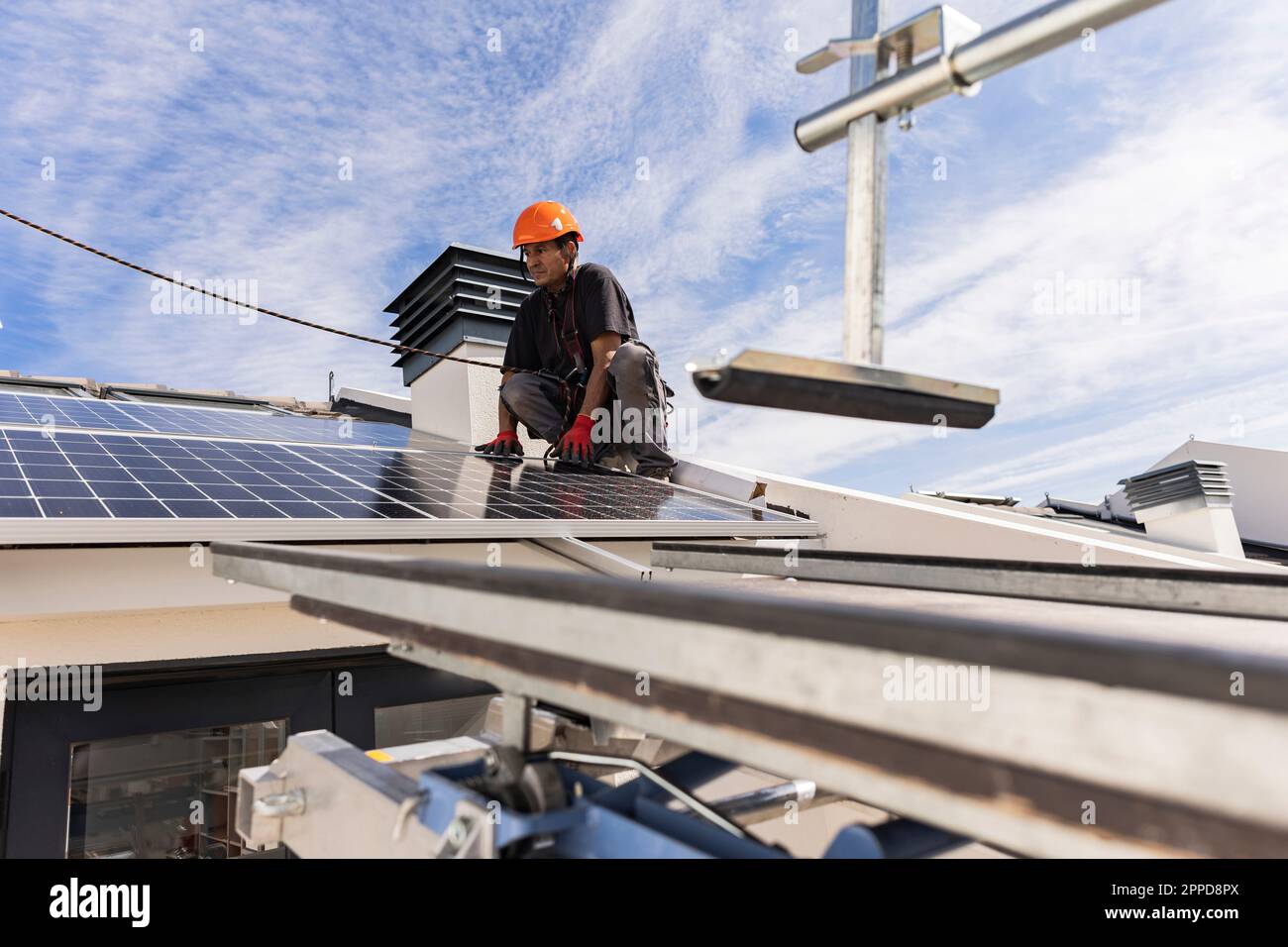 Engineer installing solar panels under cloudy sky Stock Photo - Alamy