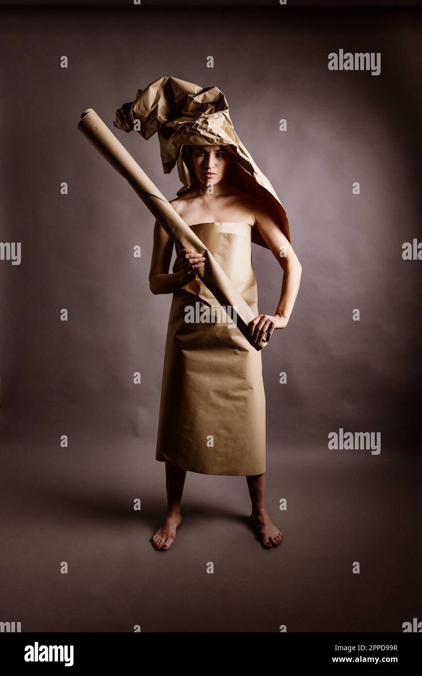 Woman wrapped in brown paper Stock Photo - Alamy