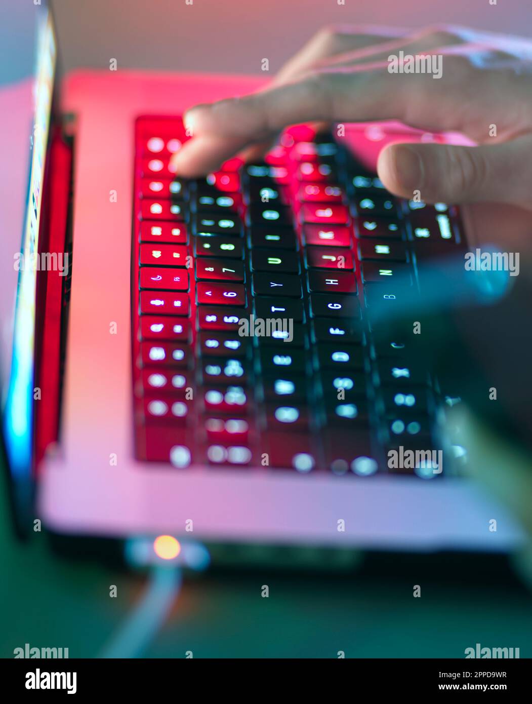 Man typing on illuminated keyboard at office Stock Photo - Alamy