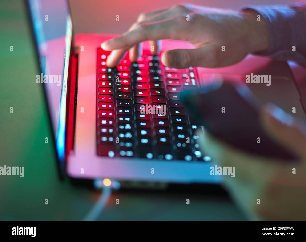 Hands typing on laptop keyboard in dark at office Stock Photo - Alamy