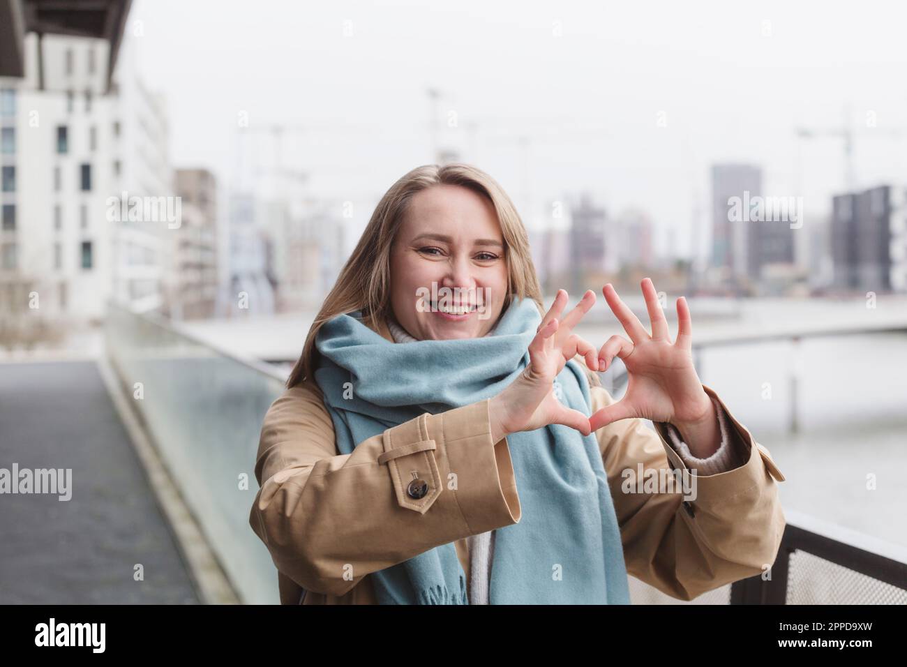Woman making heart gesture hi-res stock photography and images - Alamy