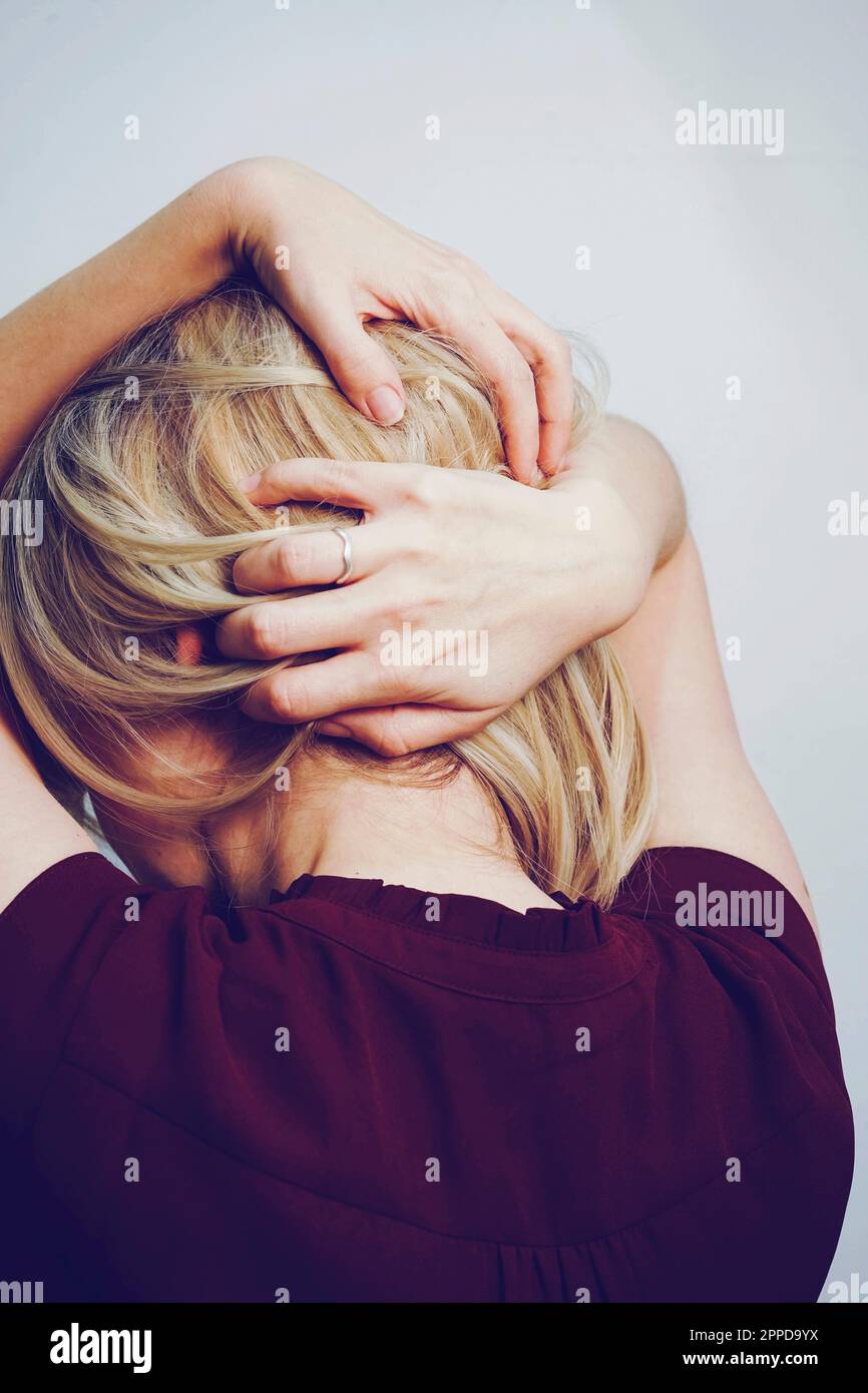 Sad blond woman wearing wedding ring Stock Photo - Alamy