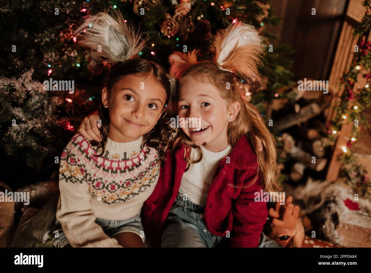 Thoughtful smiling sisters sitting hi-res stock photography and images ...