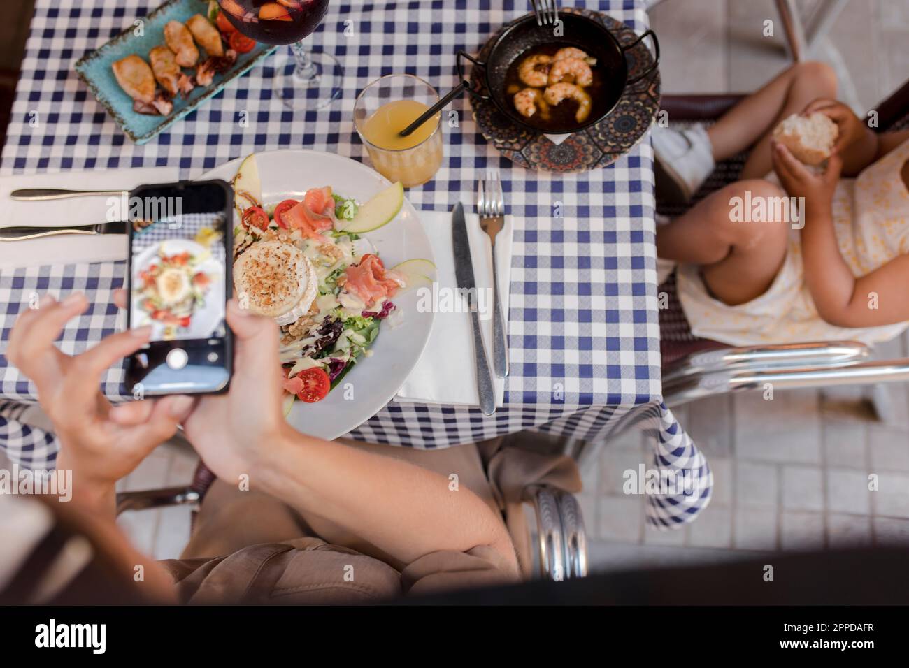 Woman photographing daughter smartphone hi-res stock photography and ...