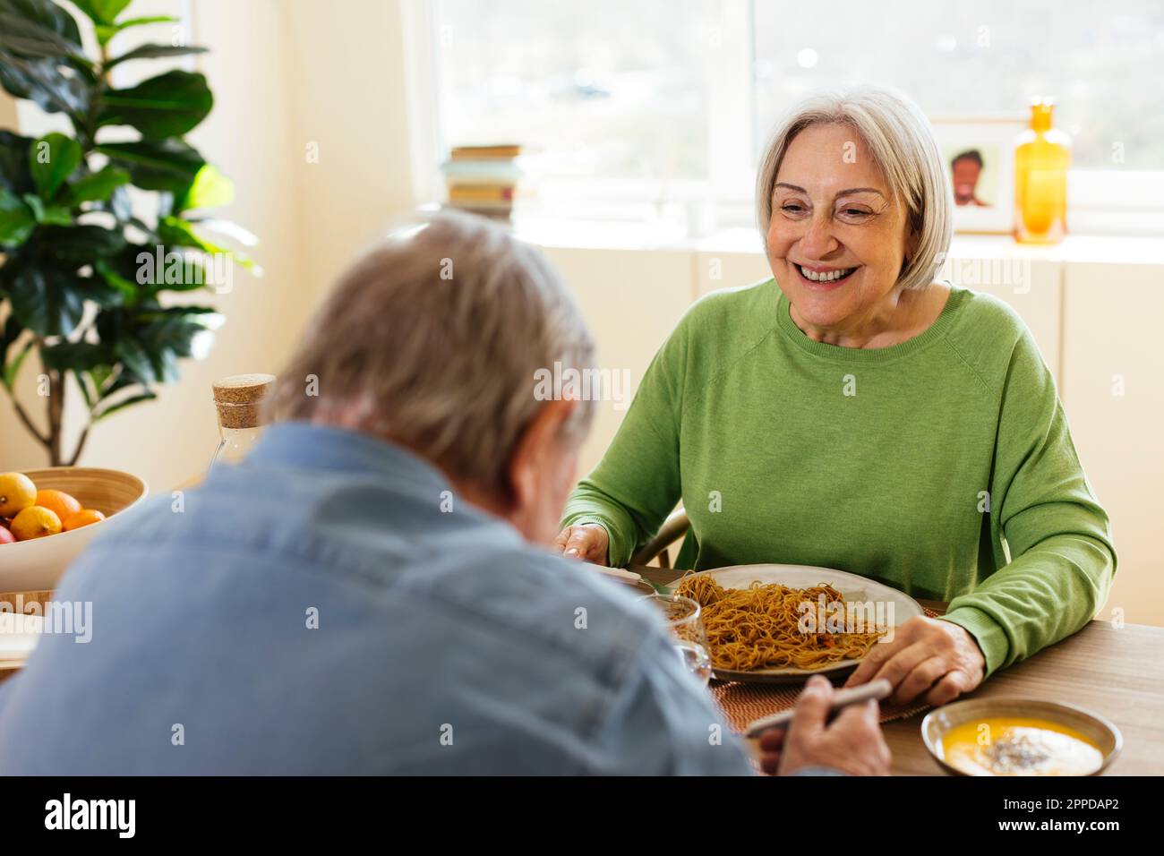 Rear view of couple sitting home hi-res stock photography and images ...